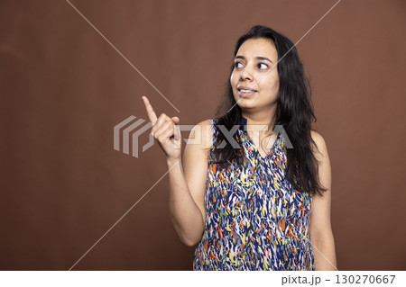 Beautiful indian woman pointing sideways to...の写真素材 [130270667] - PIXTA