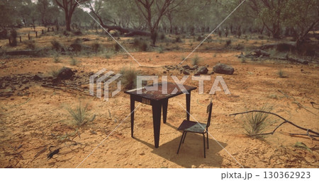 A lonely desk and chair sit abandoned in a dry...のイラスト素材 [130362923 ...