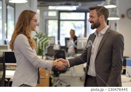 Business partners engage in handshake at modern...のイラスト素材 [130476445 ...