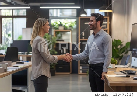 Business partners engage in handshake at modern...のイラスト素材 [130476514 ...