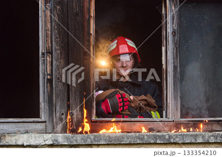 Firefighter rescuing a baby from burning...の写真素材 [133354210] - PIXTA